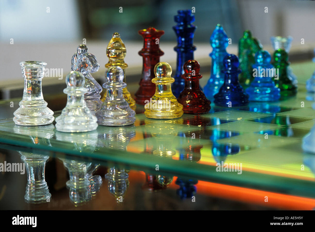 Colorful chess pieces reflecting on a glass mirror board and glass ...