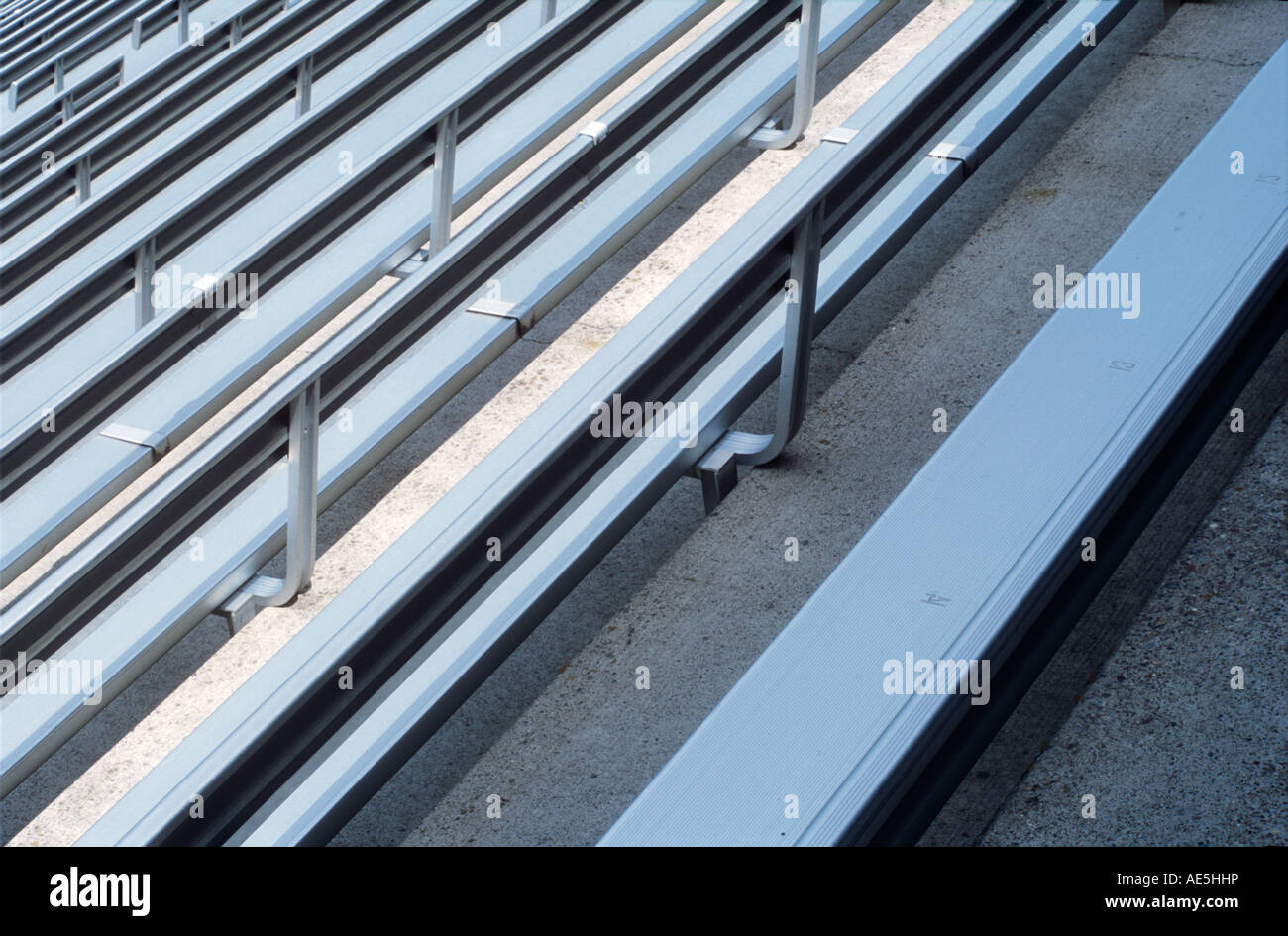 Abstract of metal bench seats in a sports stadium receding into the ...