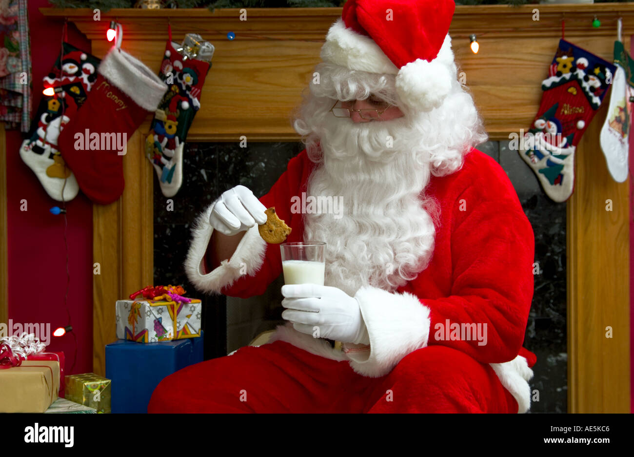 Santa with cookie and milk Stock Photo - Alamy
