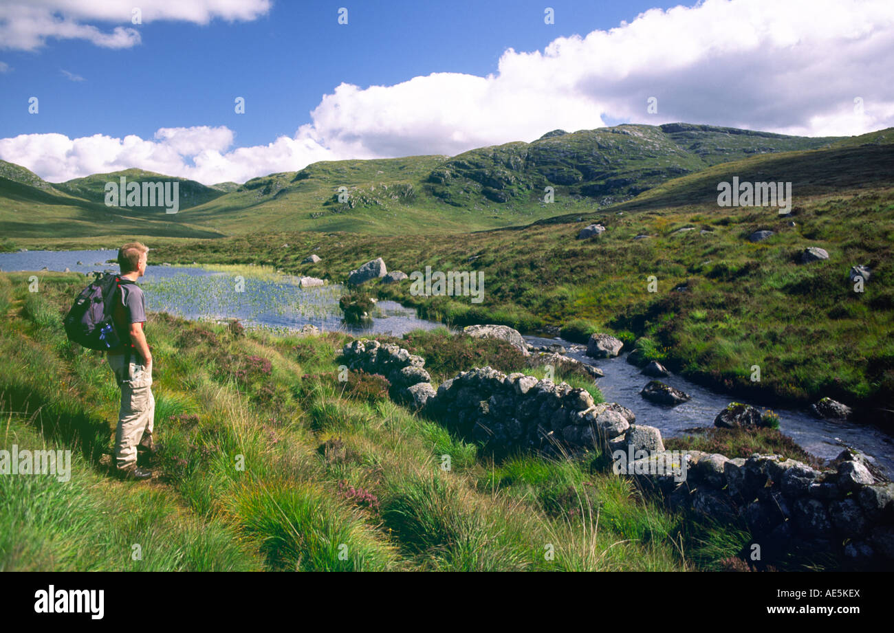 Scottish hill walking male hill walker beside burn in Galloway Hills ...