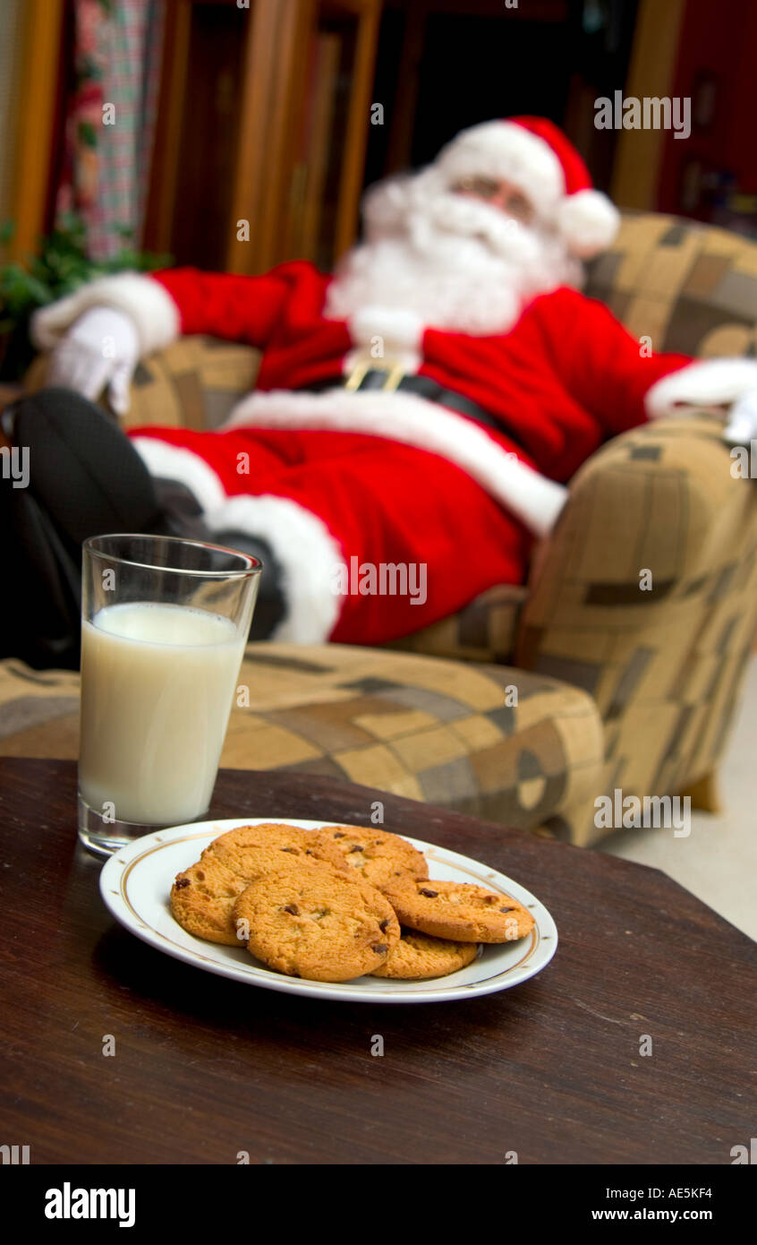 Santa sleeping on chair Stock Photo - Alamy