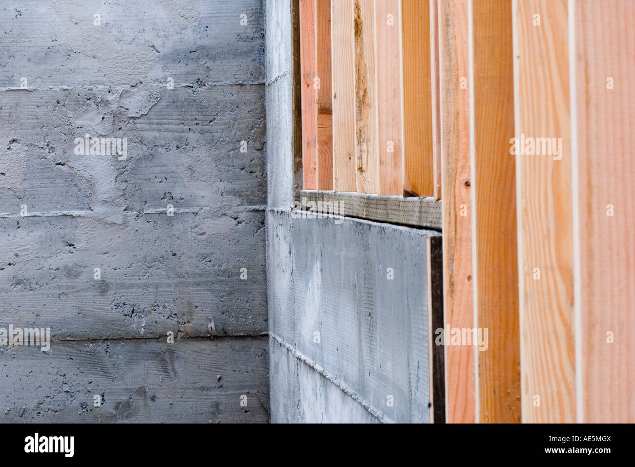 Concrete foundation wall with wood studs sitting on a mud sill at a ...