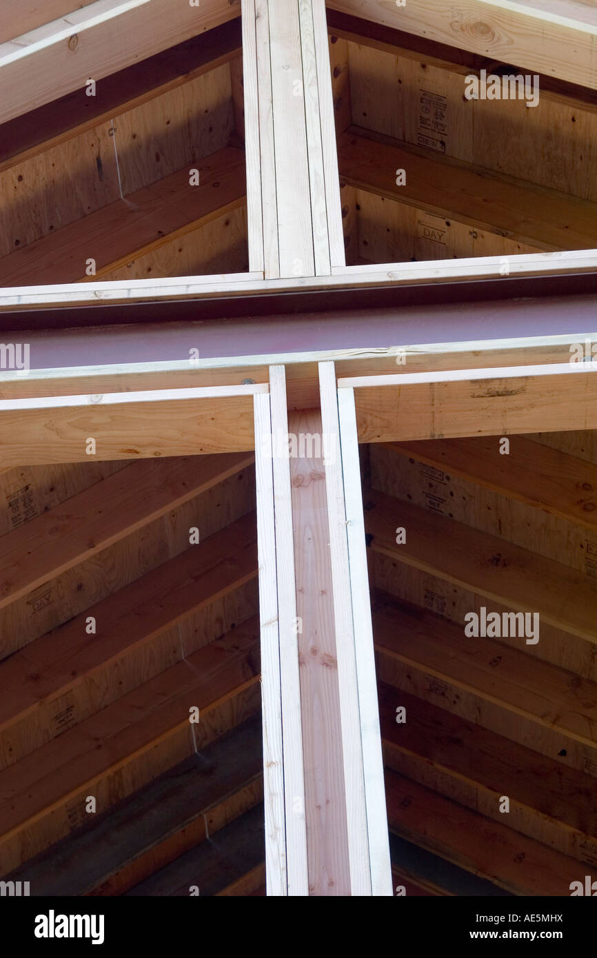 Looking up through cross formed by windows framed in metal and wood ...