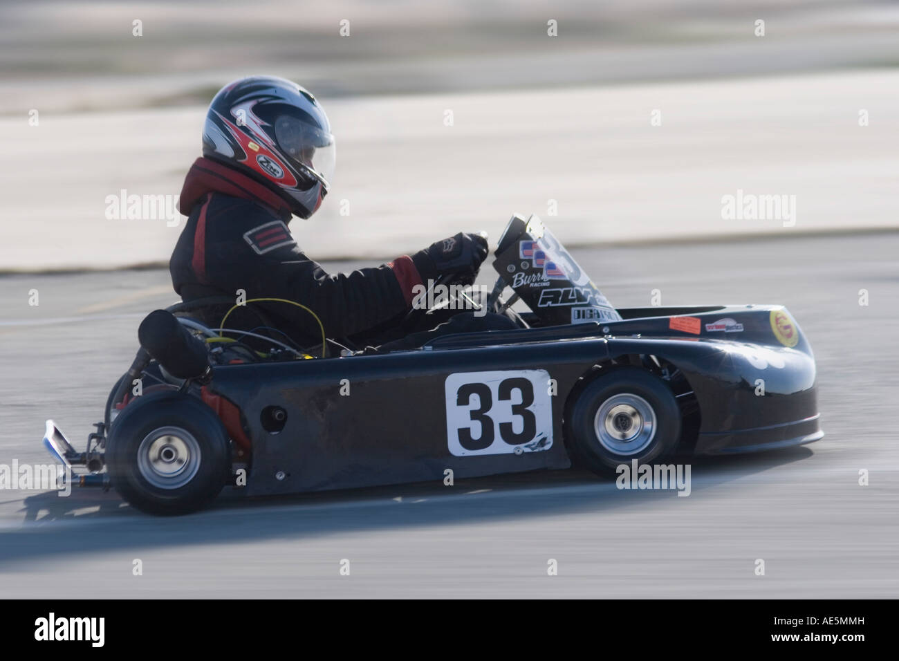 Go kart racer in kart number 33 whizzing by on an asphalt track Stock ...