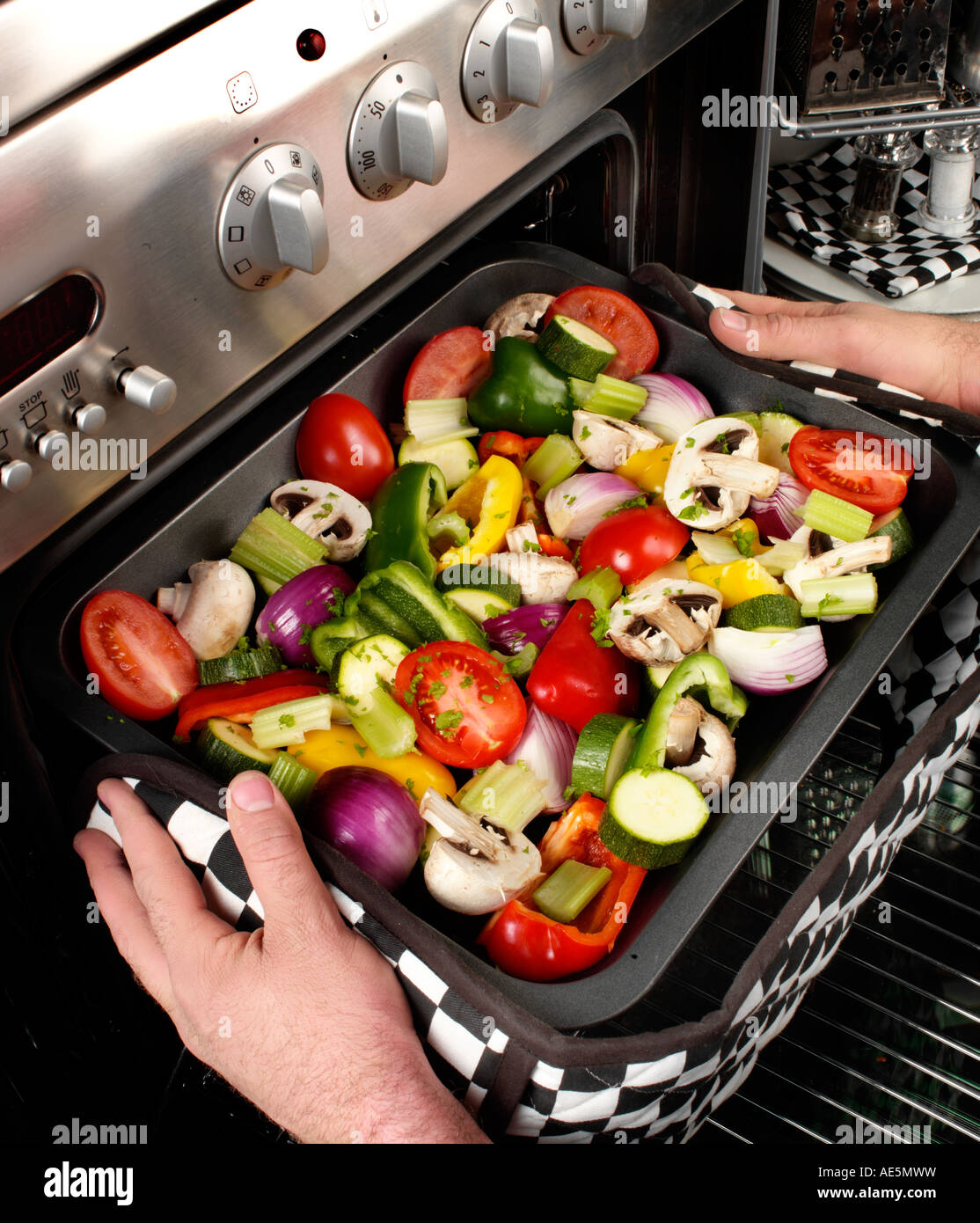 MAN ROASTING VEGTABLES Stock Photo - Alamy