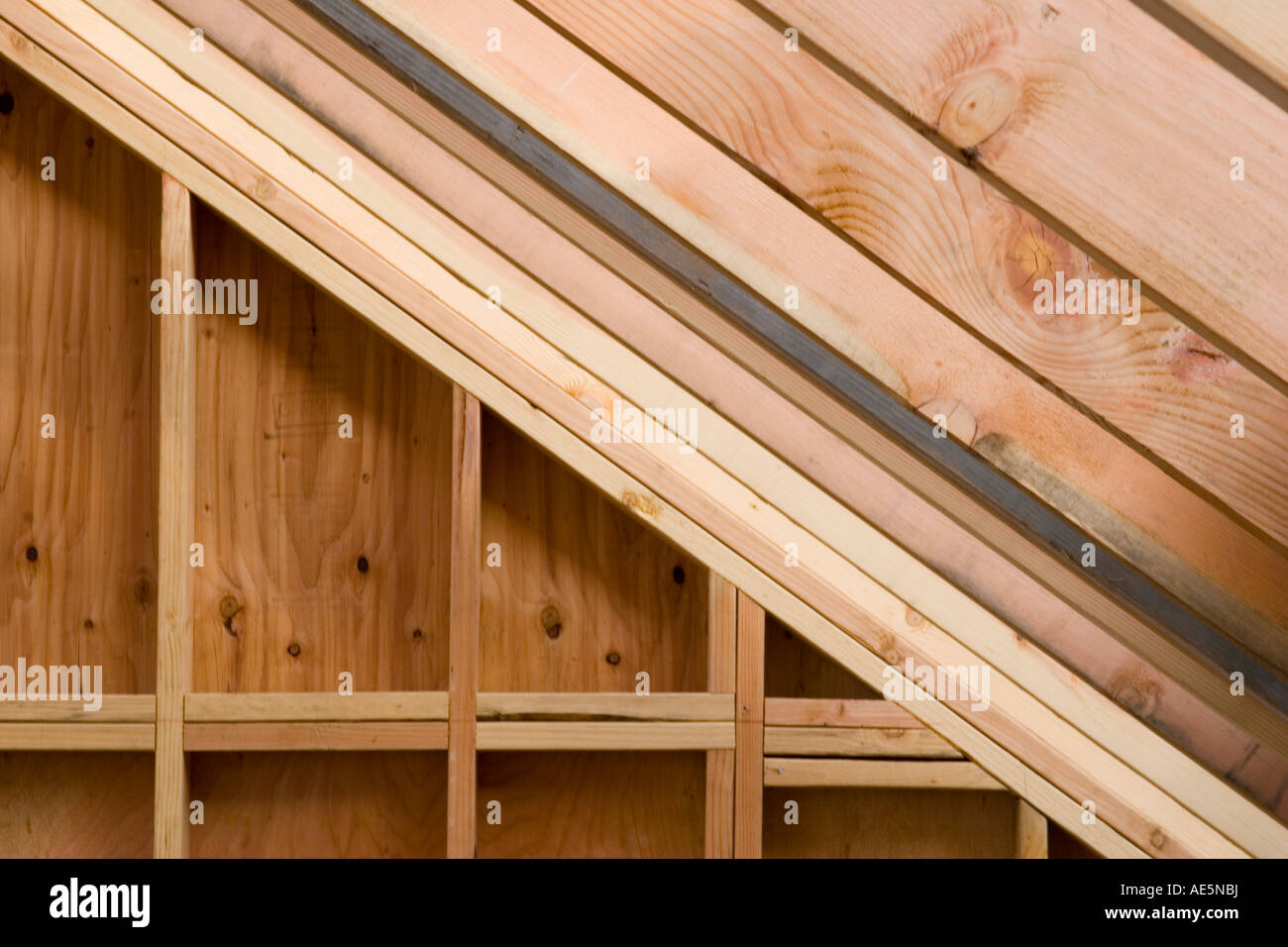 Row of roof rafters and wall studs of a framed wall at a home remodel ...