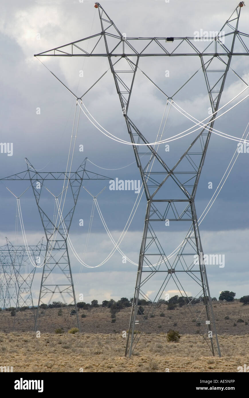 Power lines curving from tower to tower in the desert of Northern ...