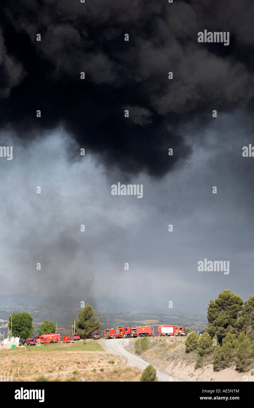 Firefighters under smoke from a fire Stock Photo - Alamy