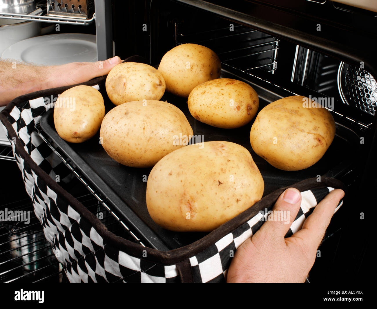 MAN BAKING POTATOES Stock Photo - Alamy