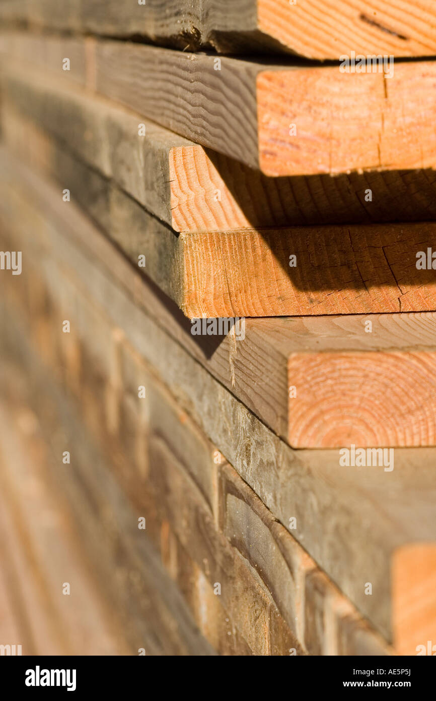 Long planks of two by ten fir wood stacked at a construction site as ...