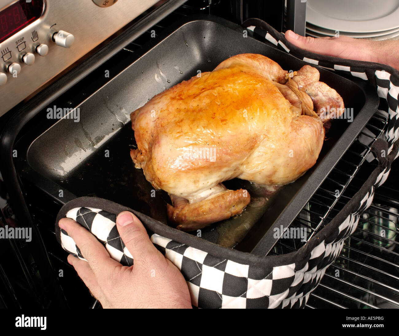 Man roasting chicken hi-res stock photography and images - Alamy