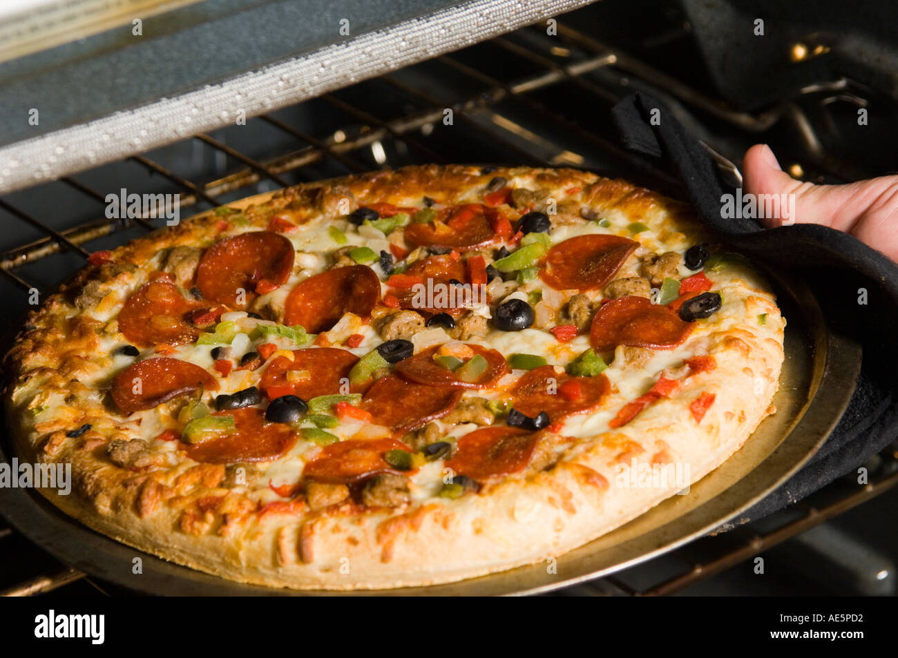 Man taking pizza out oven hi-res stock photography and images - Alamy