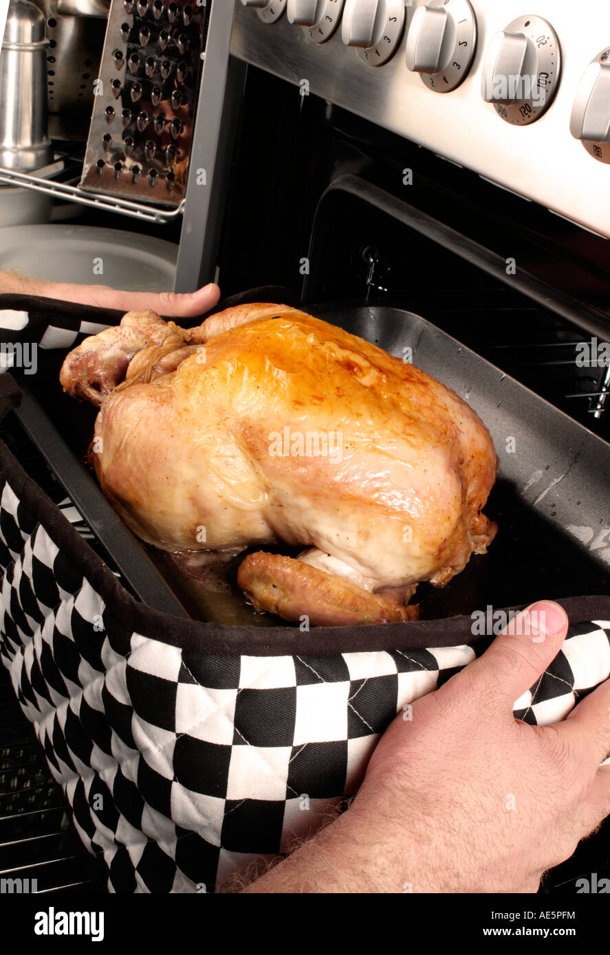 MAN ROASTING CHICKEN Stock Photo - Alamy