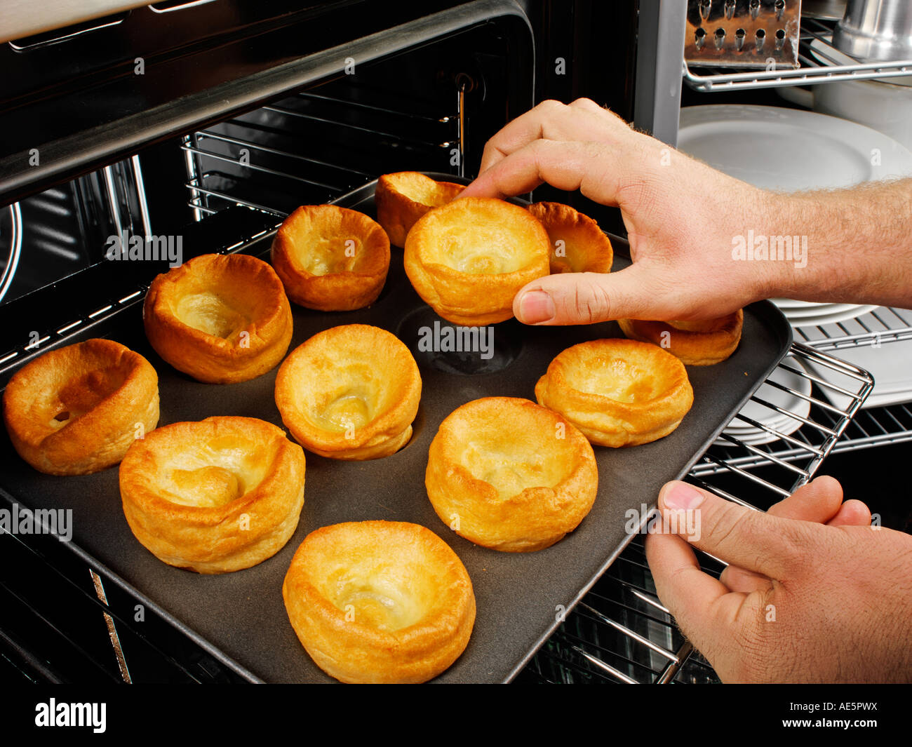 MAN COOKING YORKSHIRE PUDDINGS Stock Photo - Alamy