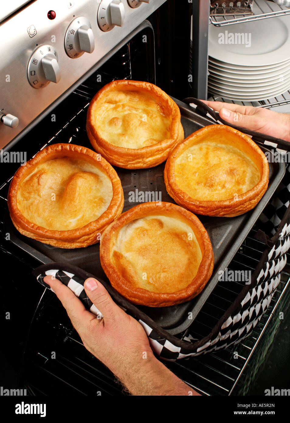 MAN COOKING GIANT YORKSHIRE PUDDINGS Stock Photo - Alamy