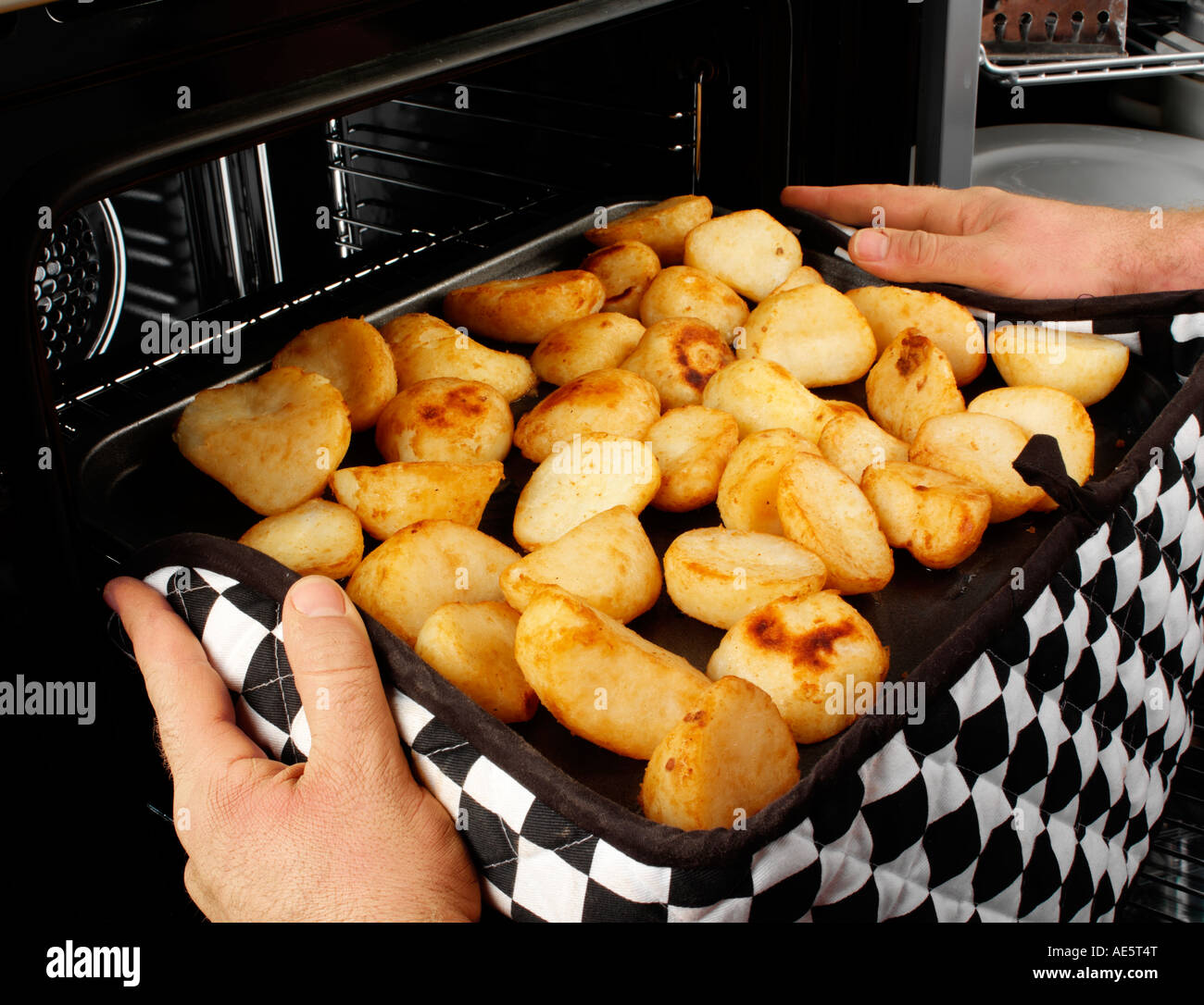 MAN ROASTING POTATOES Stock Photo - Alamy