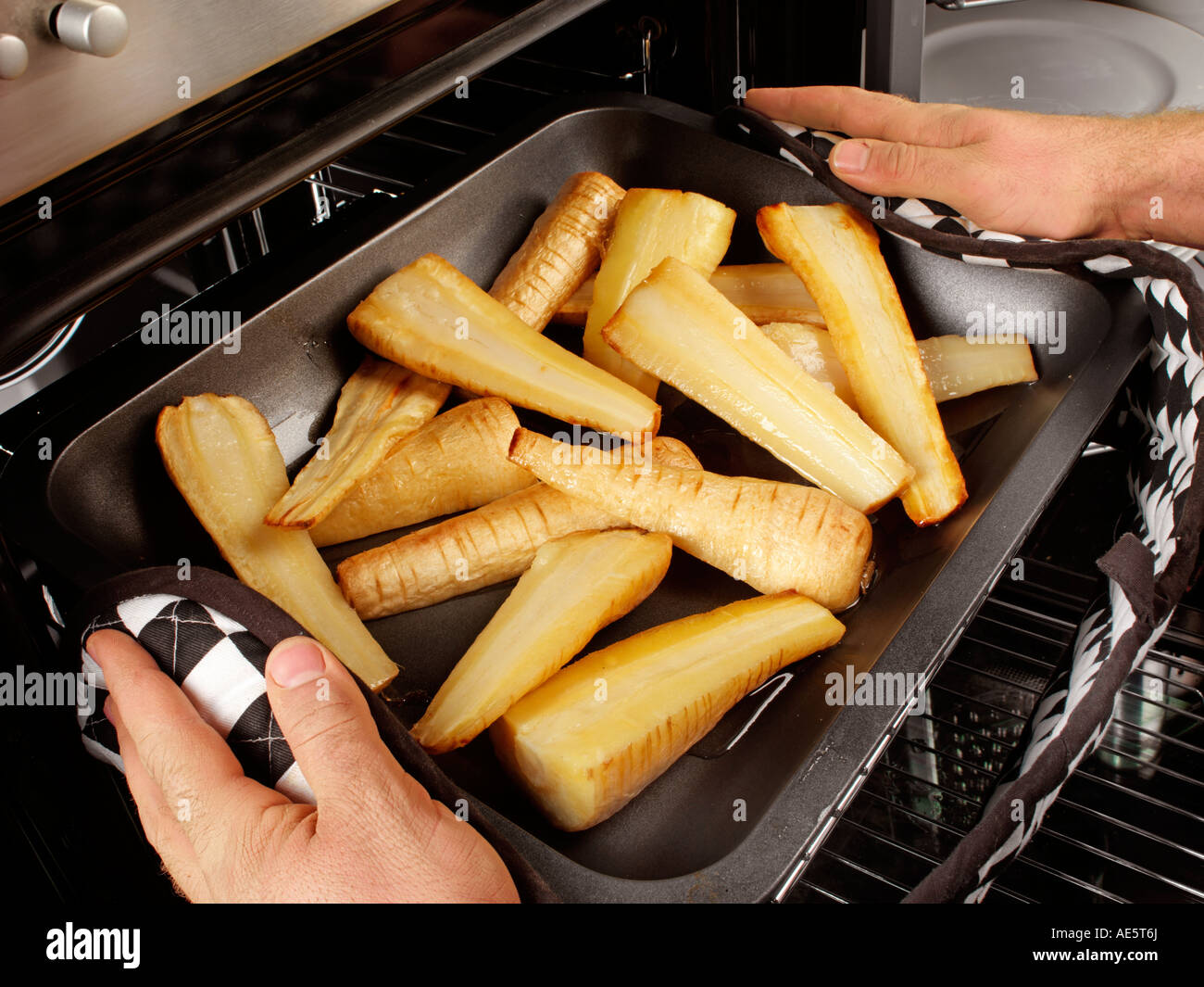 MAN ROASTING PARSNIPS Stock Photo - Alamy