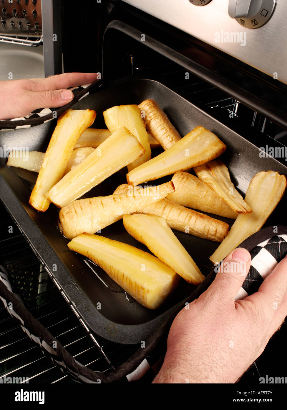 MAN ROASTING PARSNIPS Stock Photo - Alamy