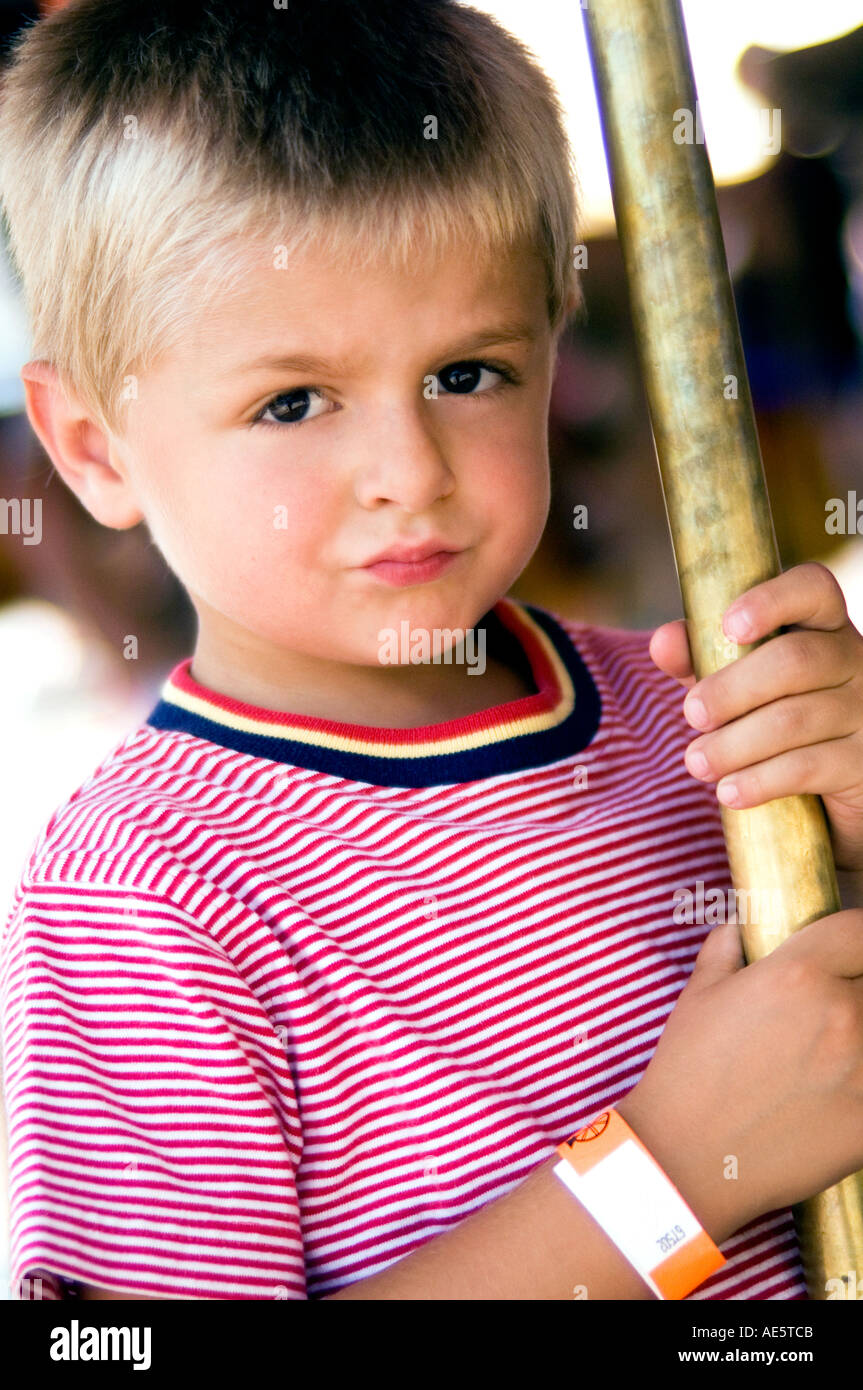 Boy on merry go round Stock Photo - Alamy