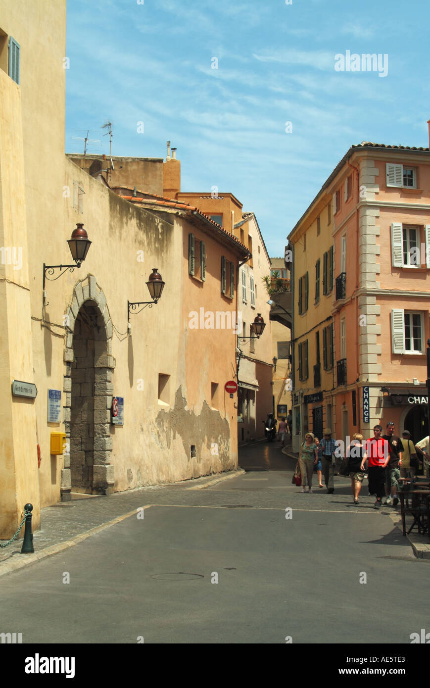 St Tropez typical old style building flanking approach to narrow street ...