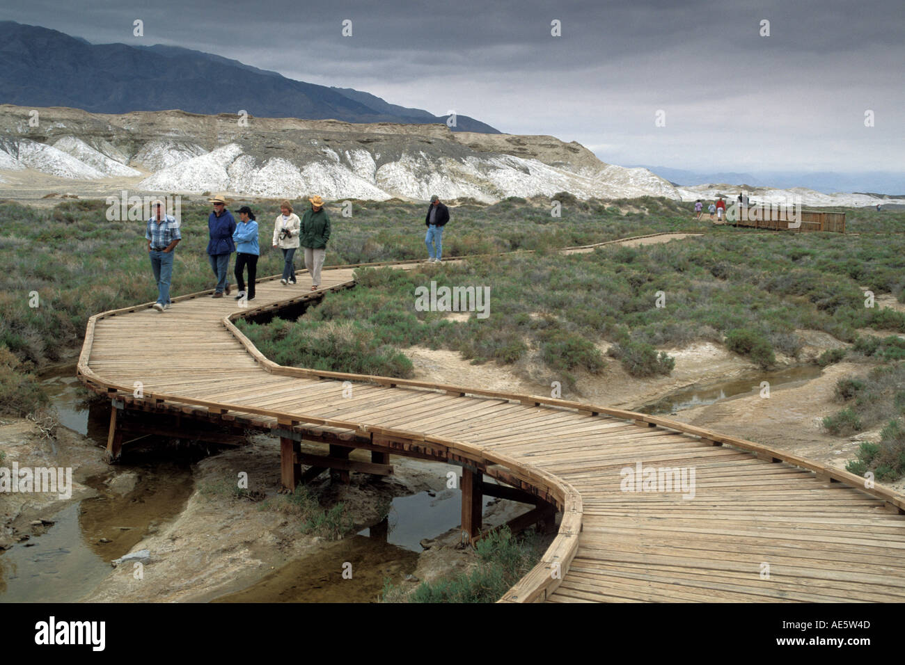 Tourists walking on wooden boardwalk nature trail path at Salt Creek ...