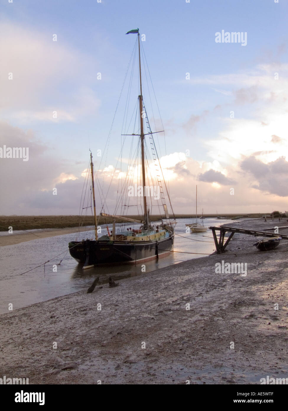 Blakeney, North Norfolk, winter sunset with traditional sailing ship ...