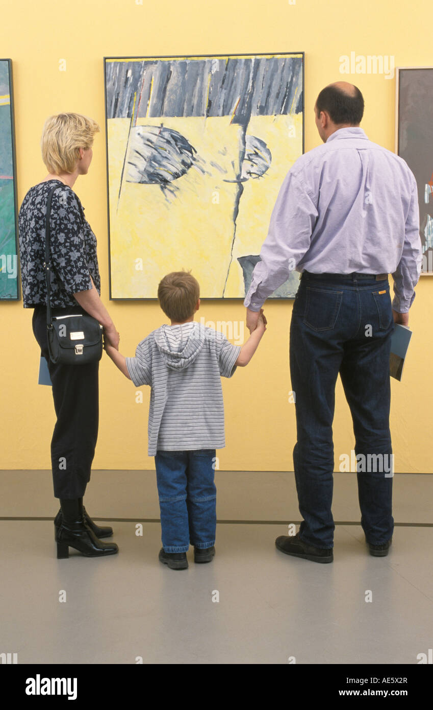 Parents with their son in a museum with modern art Stock Photo - Alamy