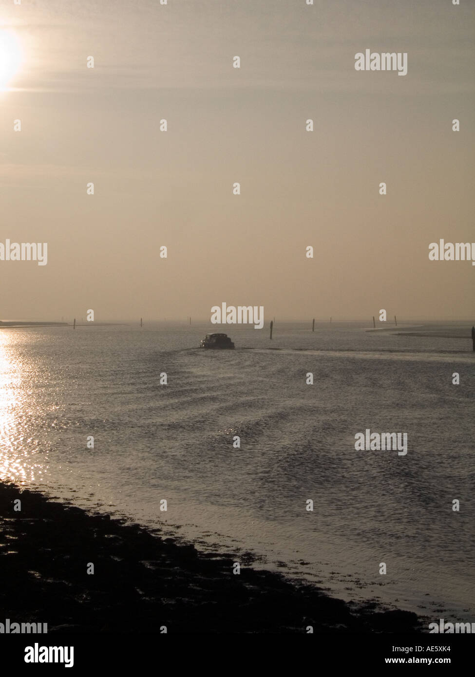 Breydon Water, Norfolk Broads at dusk with mist and boat Stock Photo ...