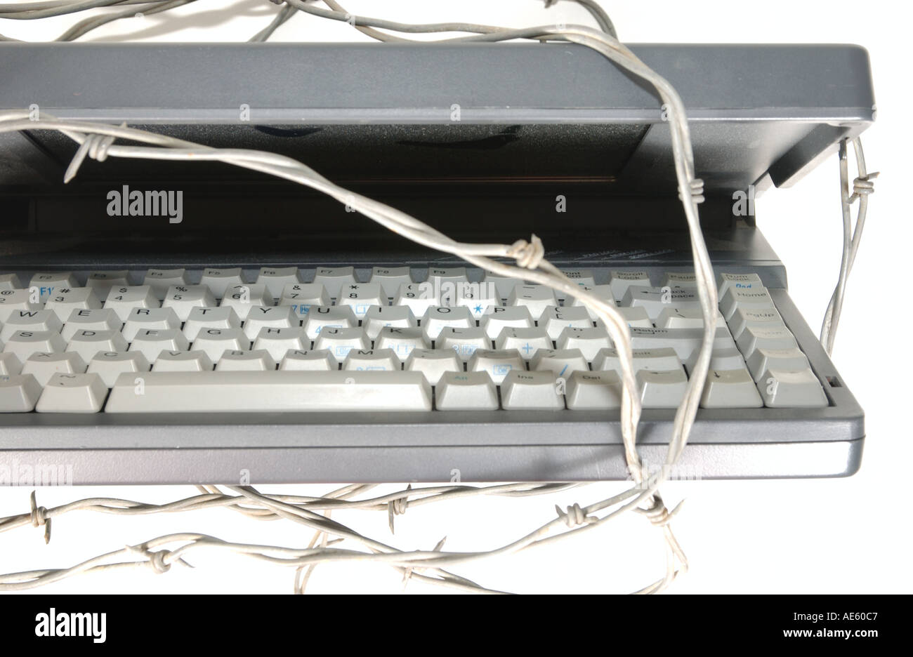 Laptop protected by barbed wire Stock Photo - Alamy