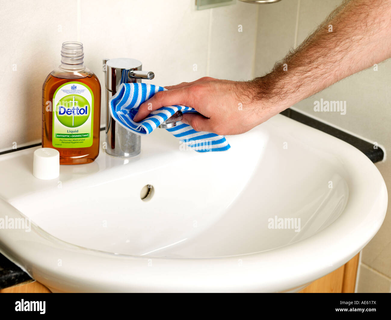 Man wiping surface clean dettol disinfectant cleaning sink tap hi-res ...