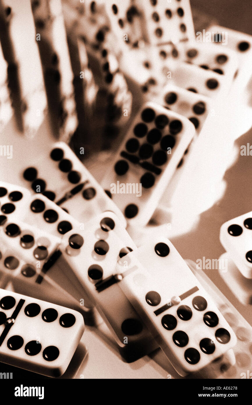 domino effect falling chain sequence game finance Stock Photo - Alamy