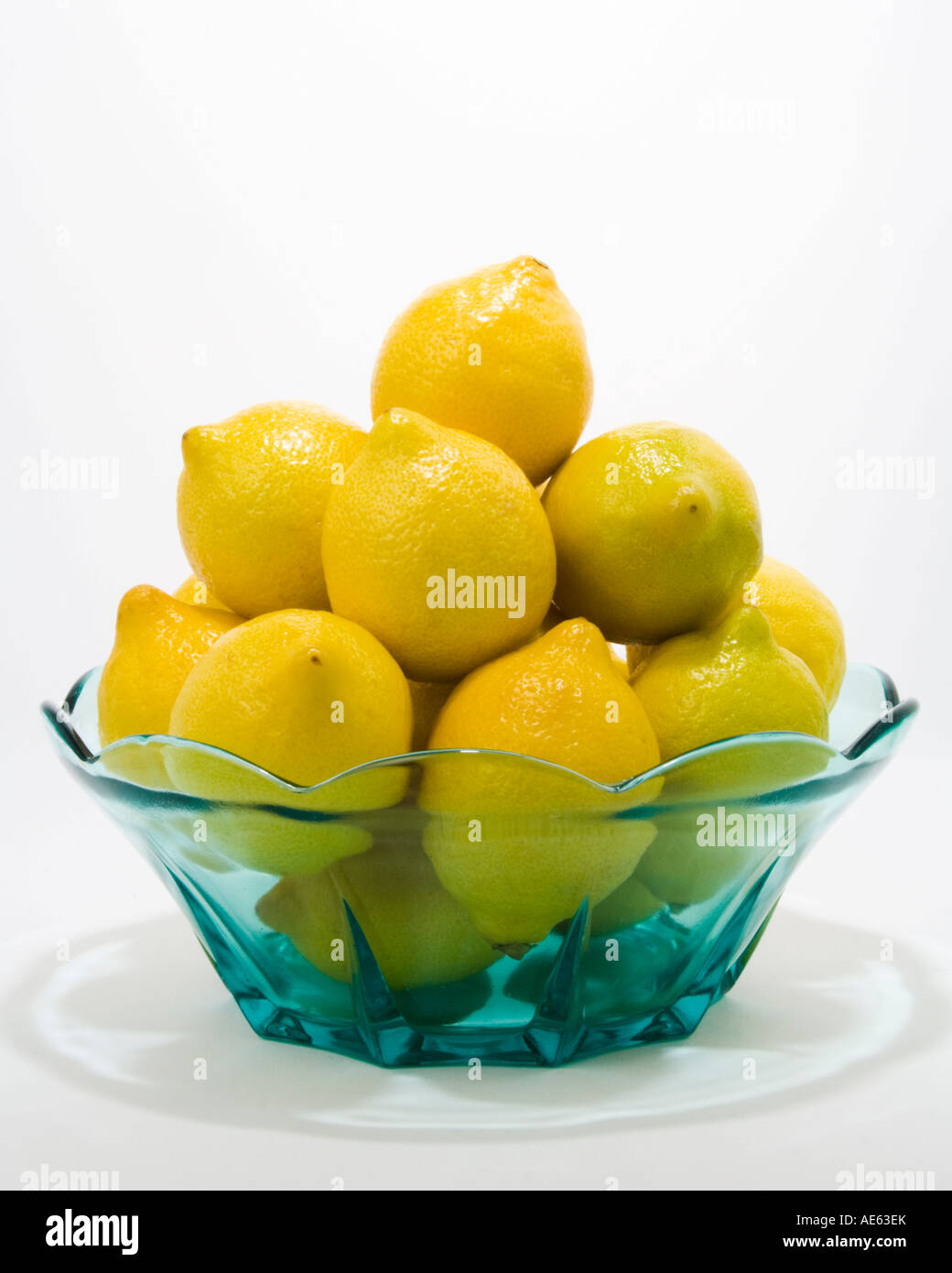 Lemons in blue glass bowl Stock Photo - Alamy
