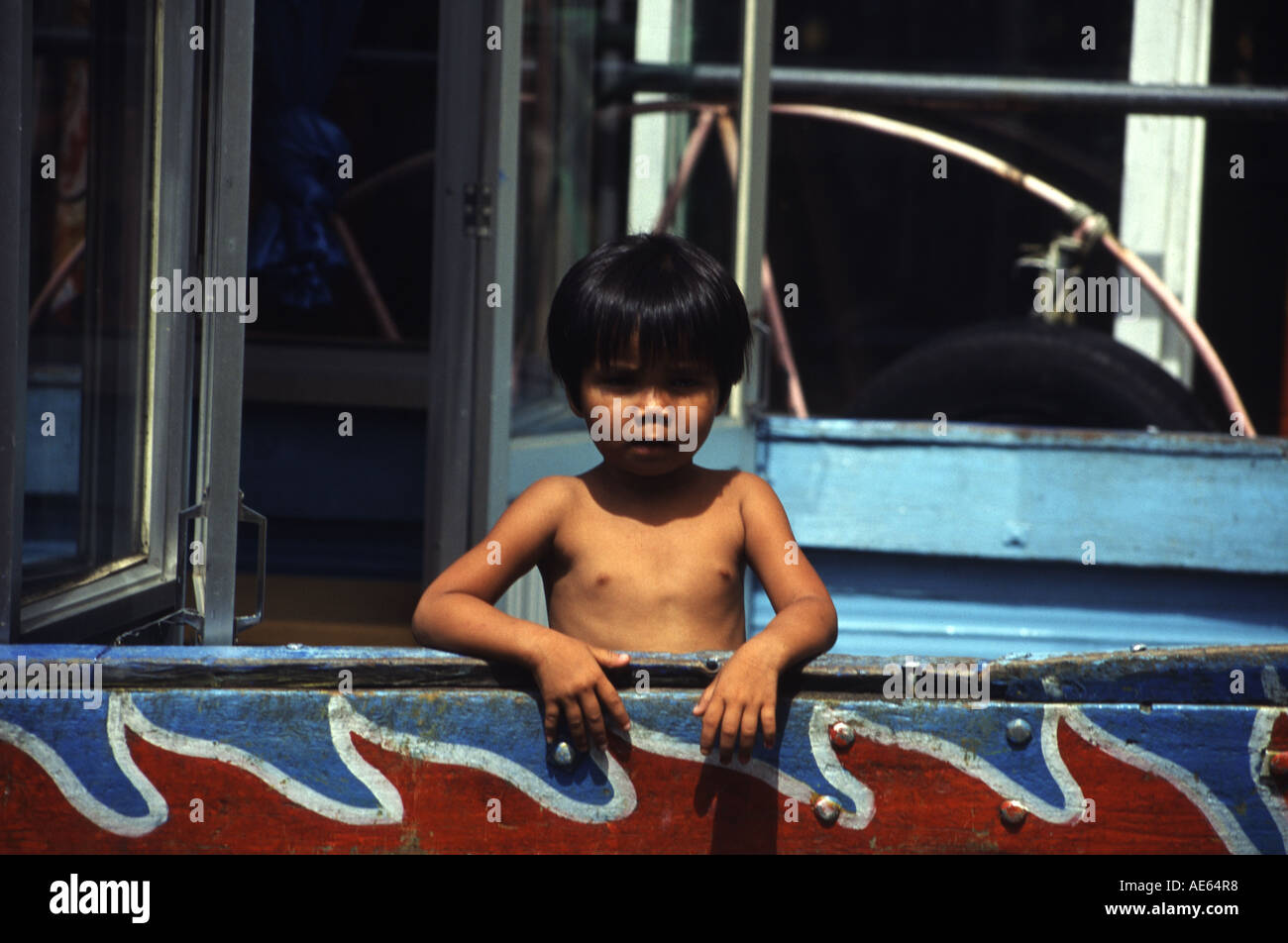 Vietnam Mekong Delta A young child watches life go by on the waters of ...