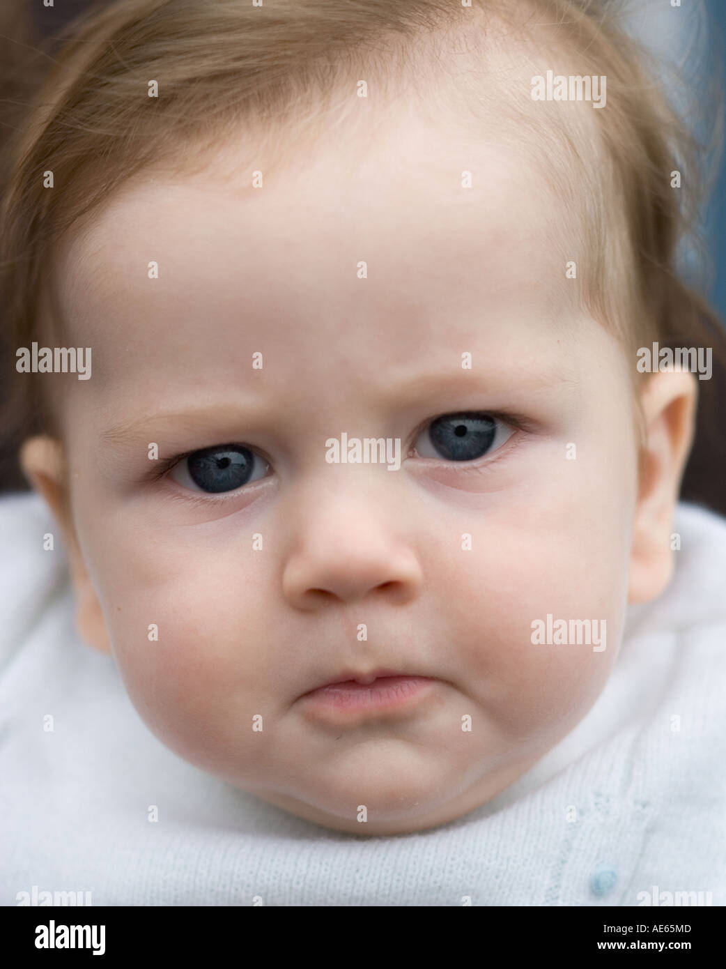 Portrait of a baby with a stern, serious expression Stock Photo - Alamy
