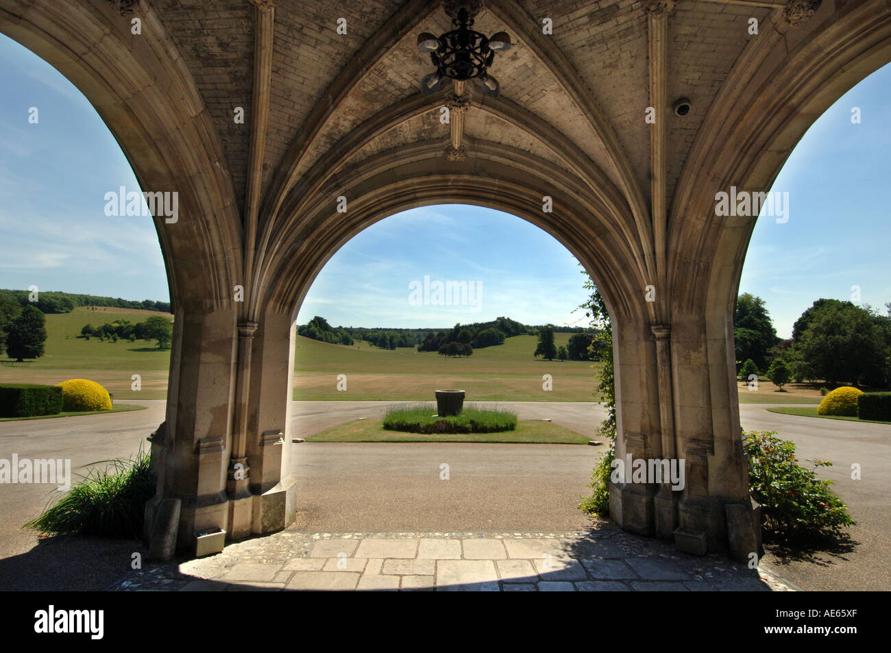 The arched porch of West Dean College with the West Sussex countryside ...