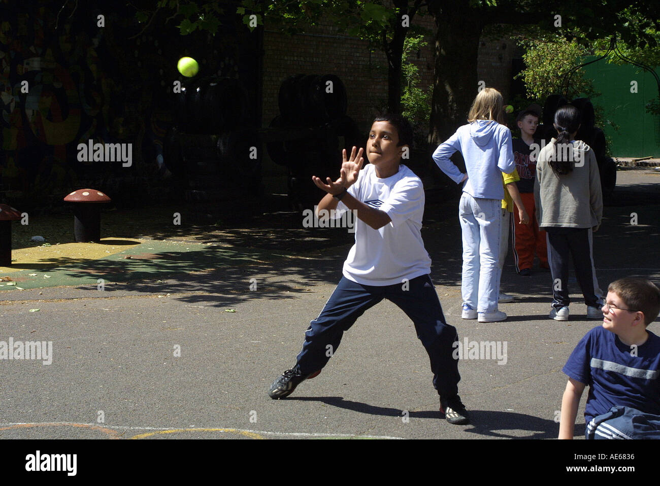 Primary school child catching ball Stock Photo - Alamy