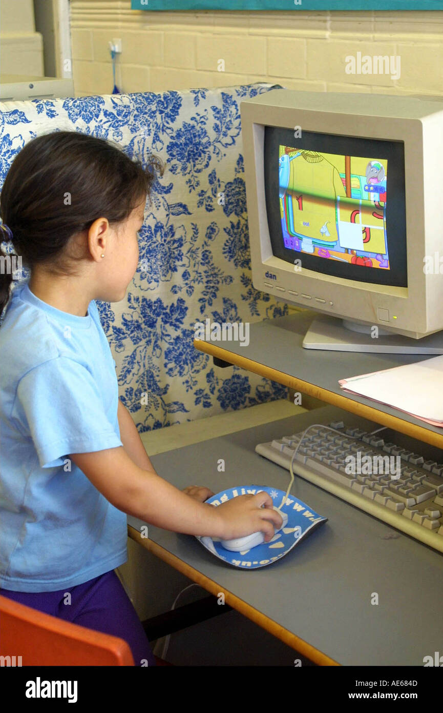 Nursery school girl using computer Stock Photo - Alamy