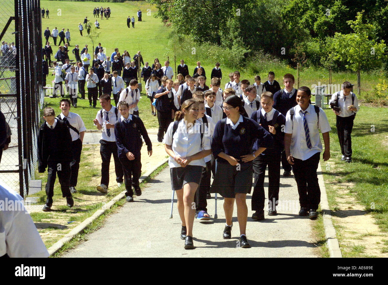 Secondary school children walking in park Stock Photo - Alamy