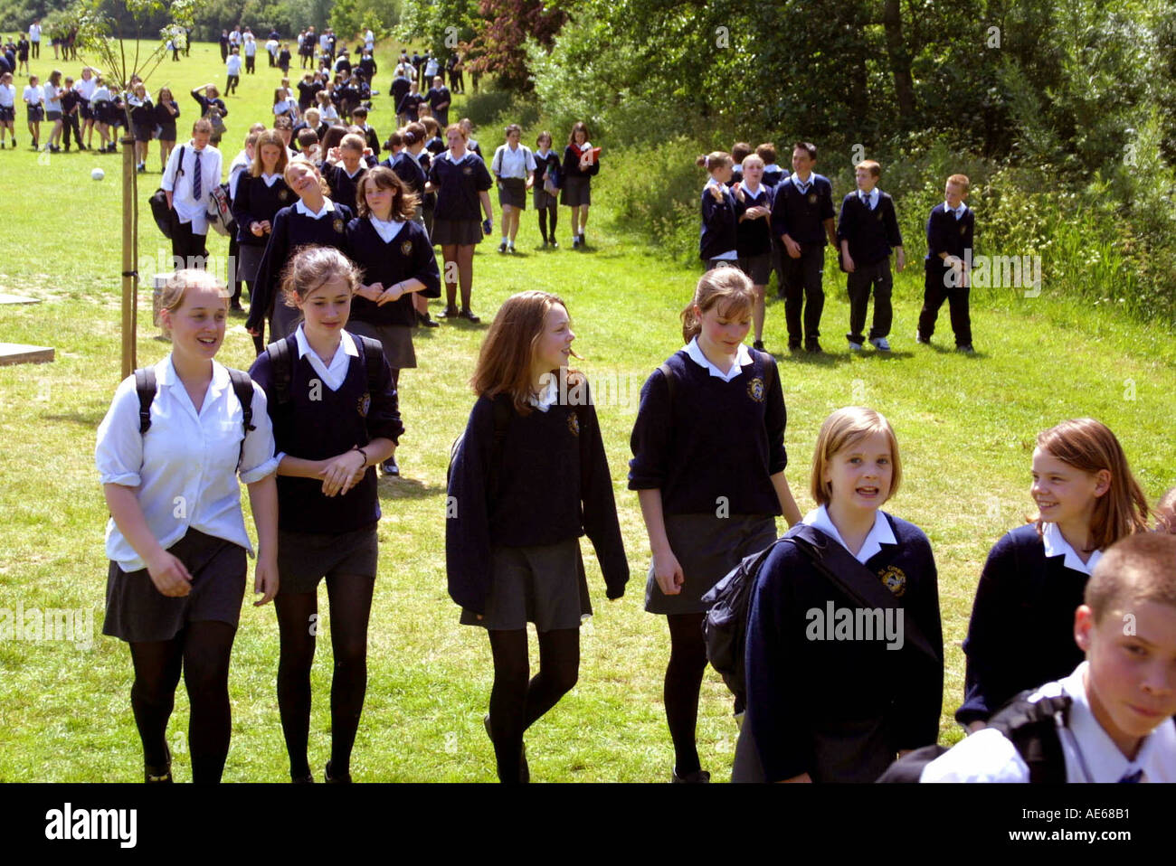 Secondary school children walking in the park Stock Photo - Alamy