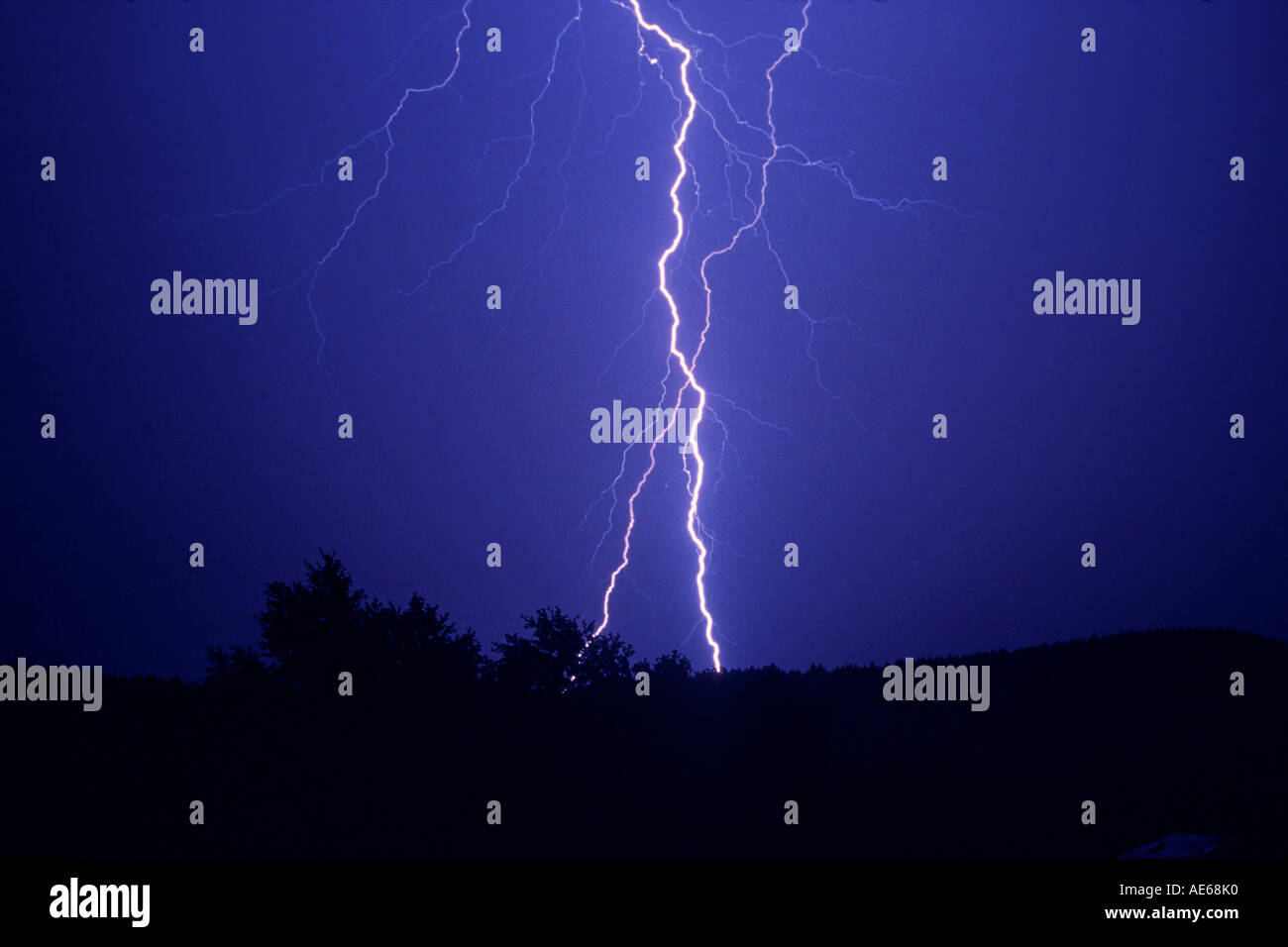 thunder storm lightning hits a hill Stock Photo - Alamy