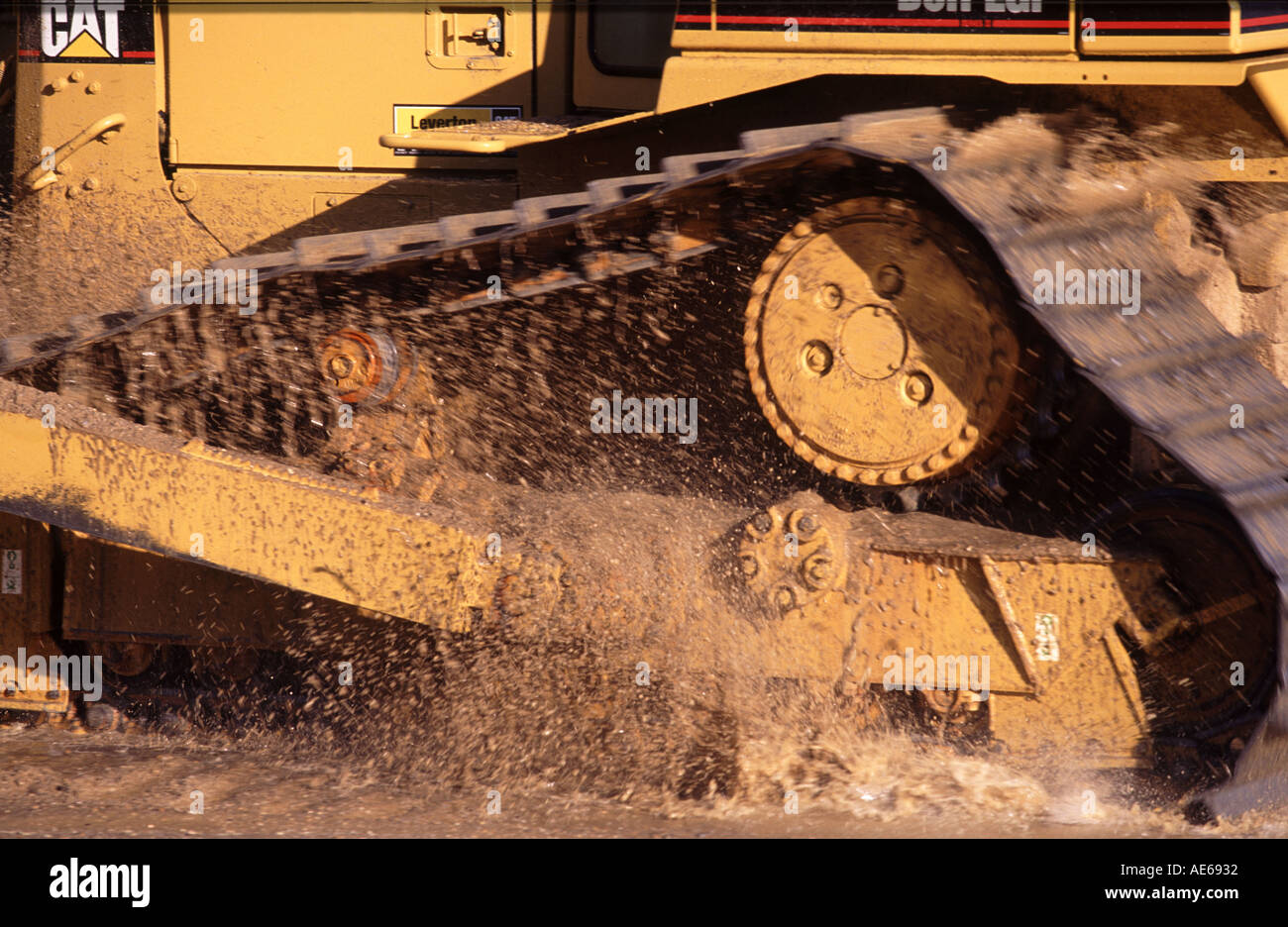 Moving Bulldozer Tracks throwing up Wet Soil Stock Photo - Alamy