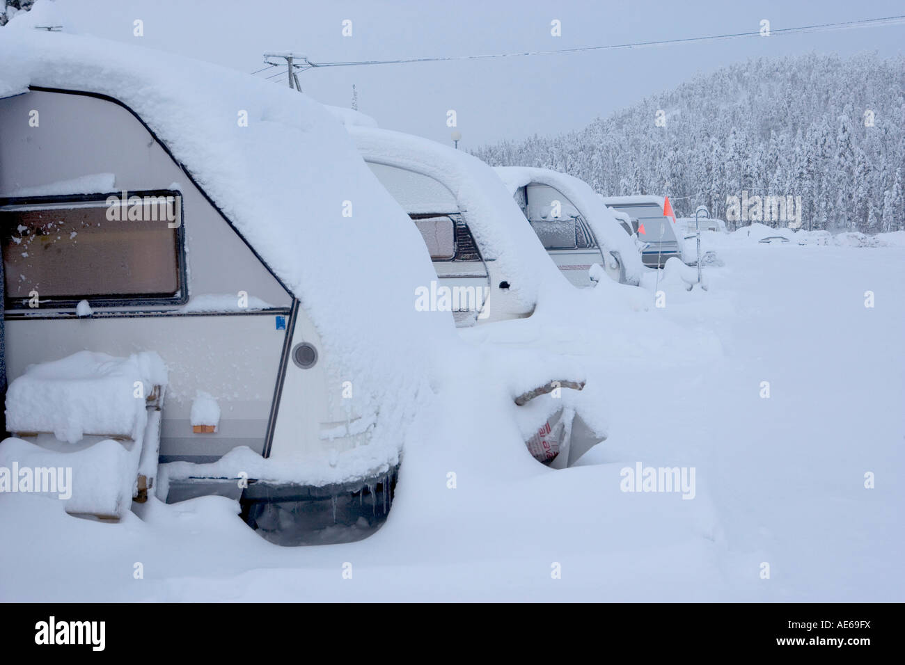 Snow covering caravans at camp site Stock Photo - Alamy