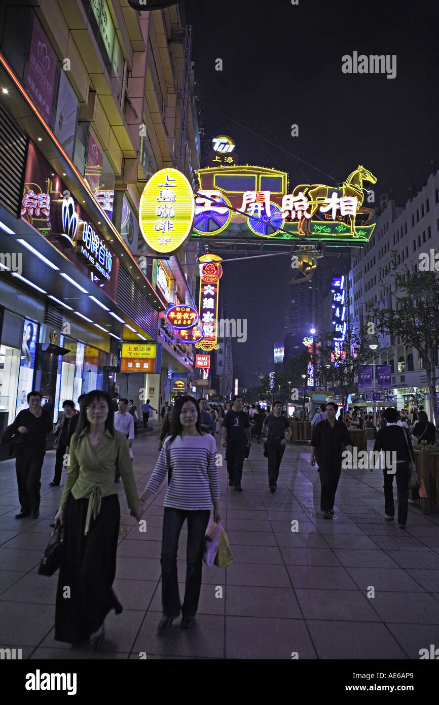 CHINA SHANGHAI Girls holding hands and late night shoppers crowding ...