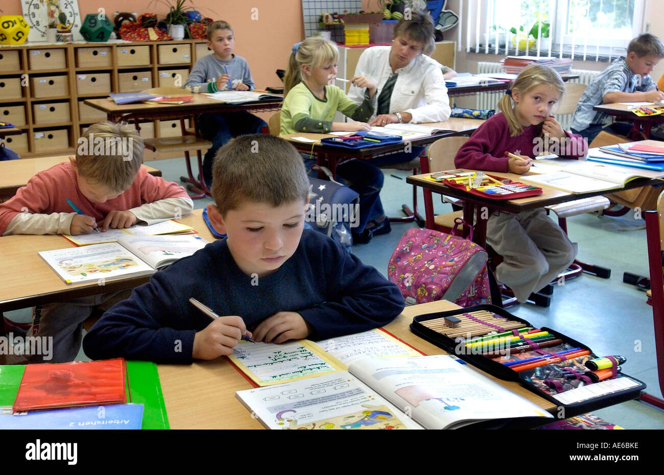 pupils writing in the classroom Stock Photo - Alamy