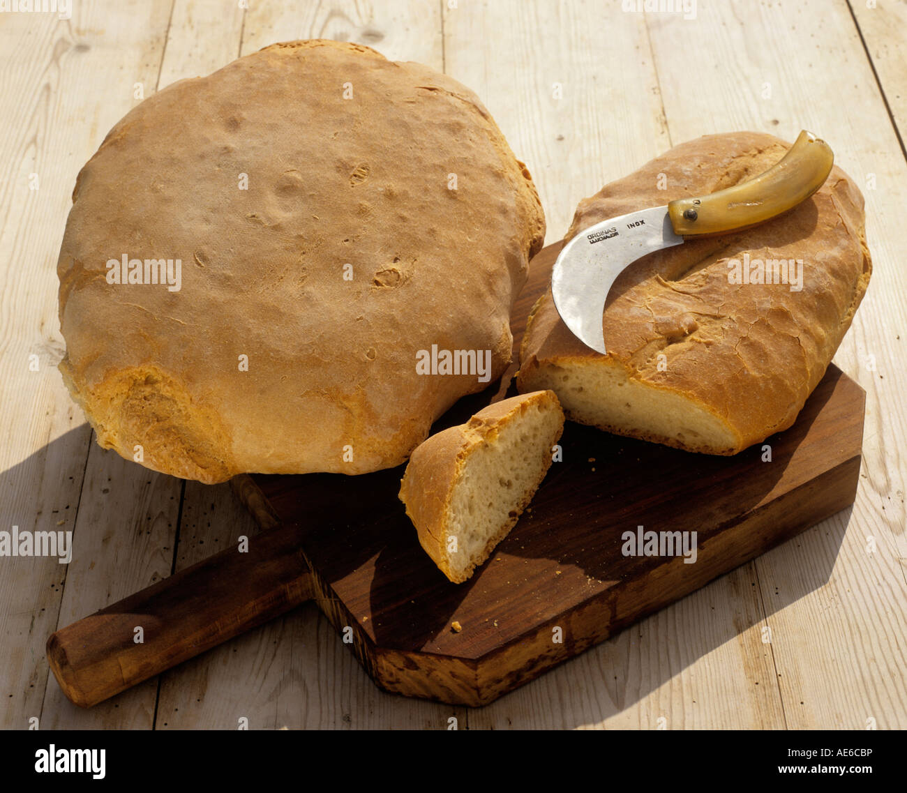 FOCACCIA BREAD CUT AND UNCUT ON OLD BREAD BOARD WITH TRADITIONAL ...