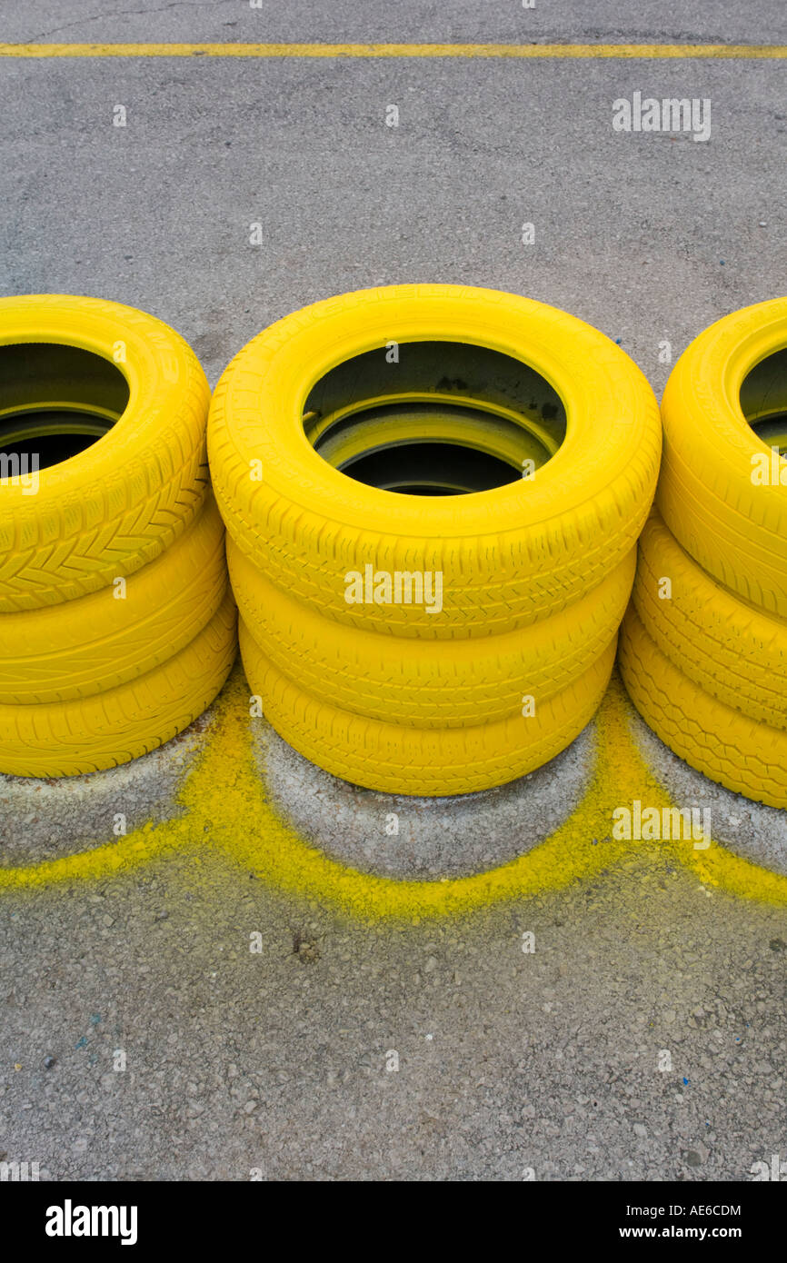 Bright yellow color rubber tires stacked on road Stock Photo - Alamy