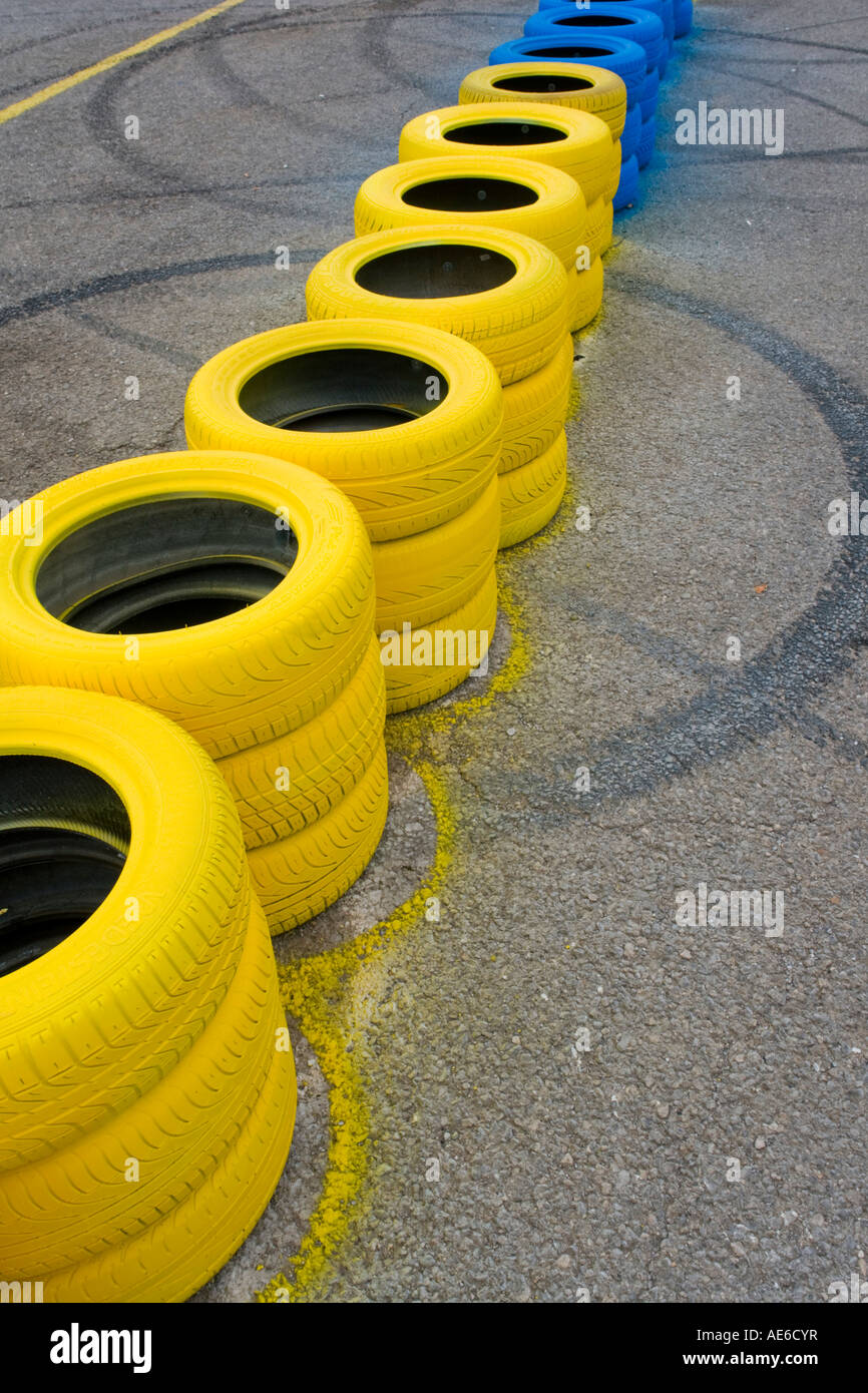 Bright yellow and blue color rubber tires stacked on road Stock Photo ...