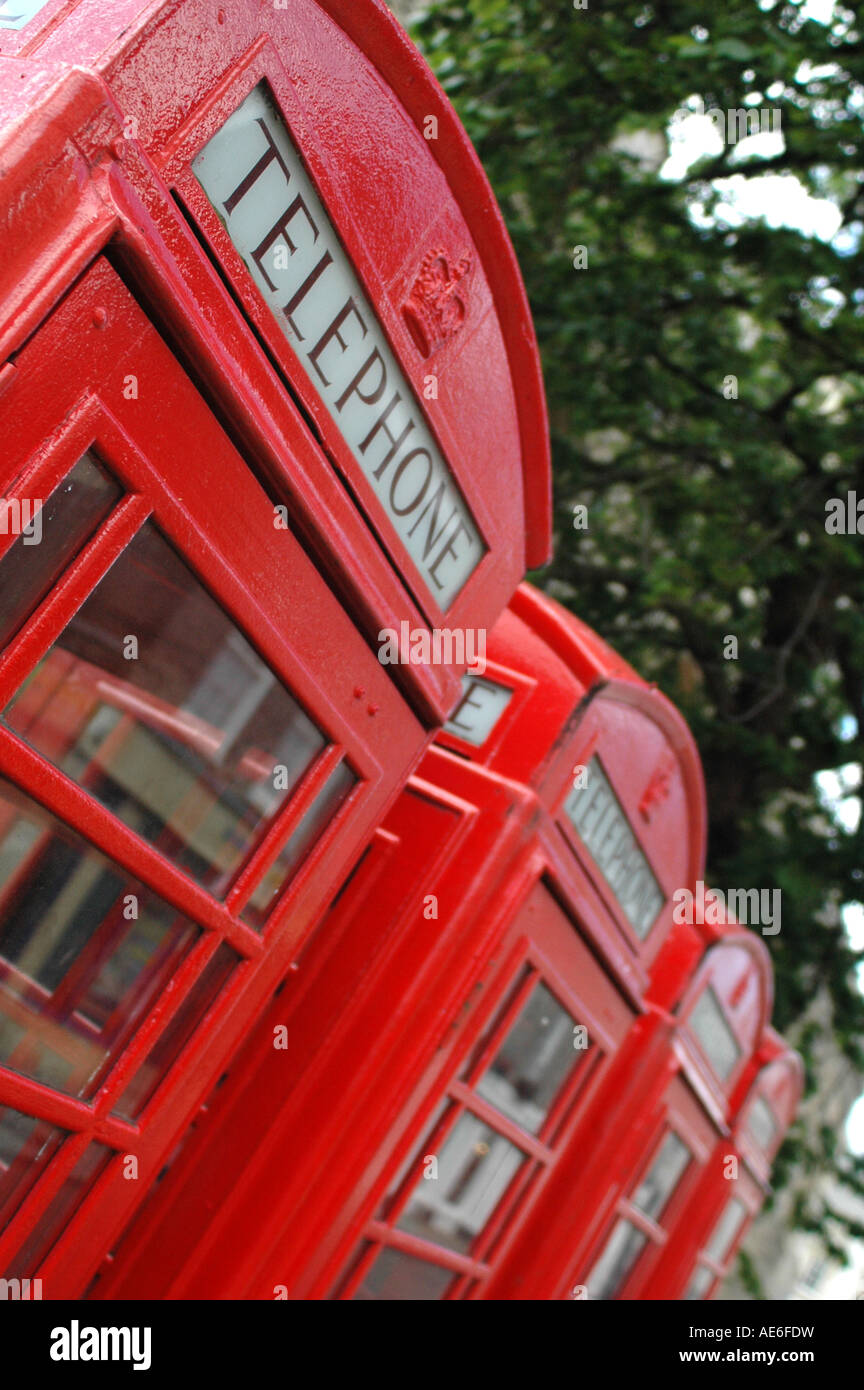 Four English red phone boxes in a row Stock Photo - Alamy