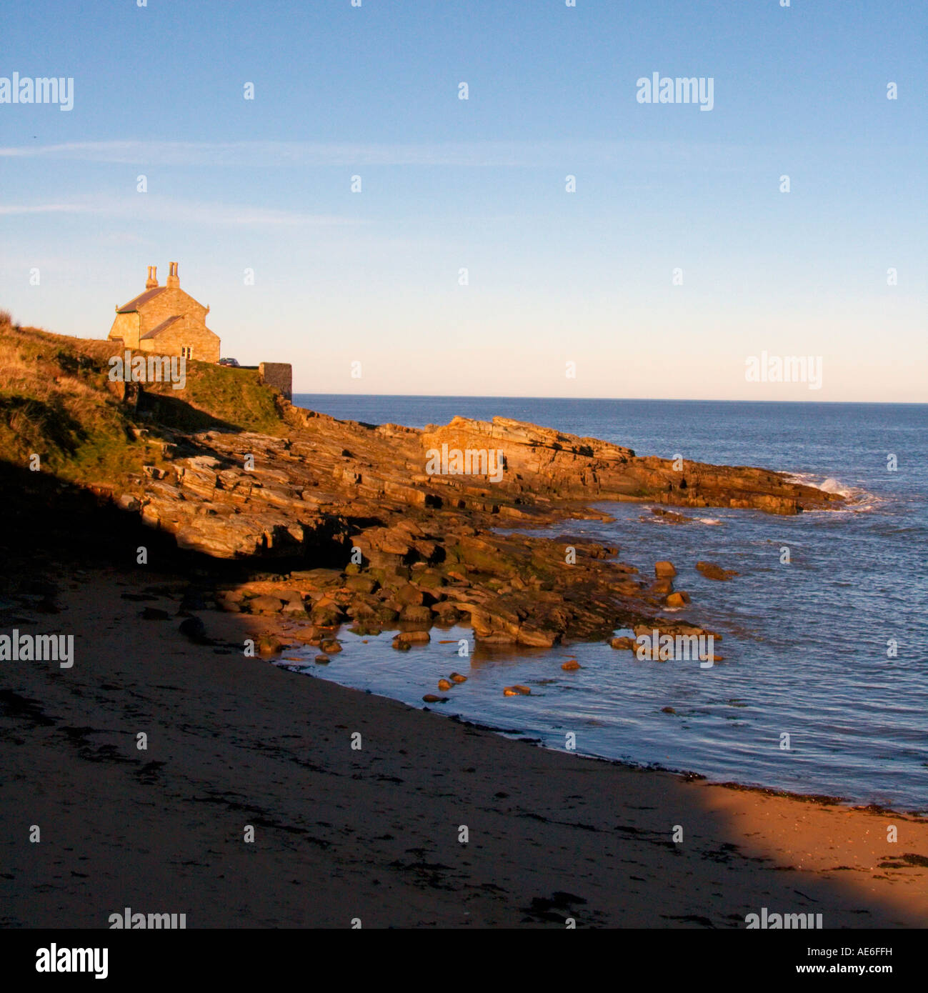 House and coastal bay near Craster Northumberland Stock Photo - Alamy