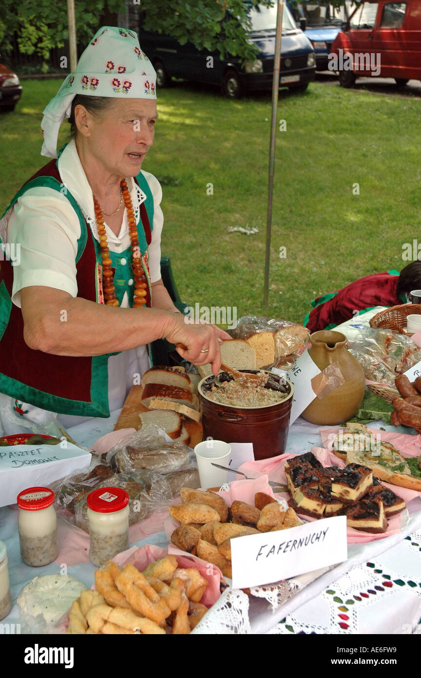 Woman in traditional polish Kurpie polish region costume selling her ...
